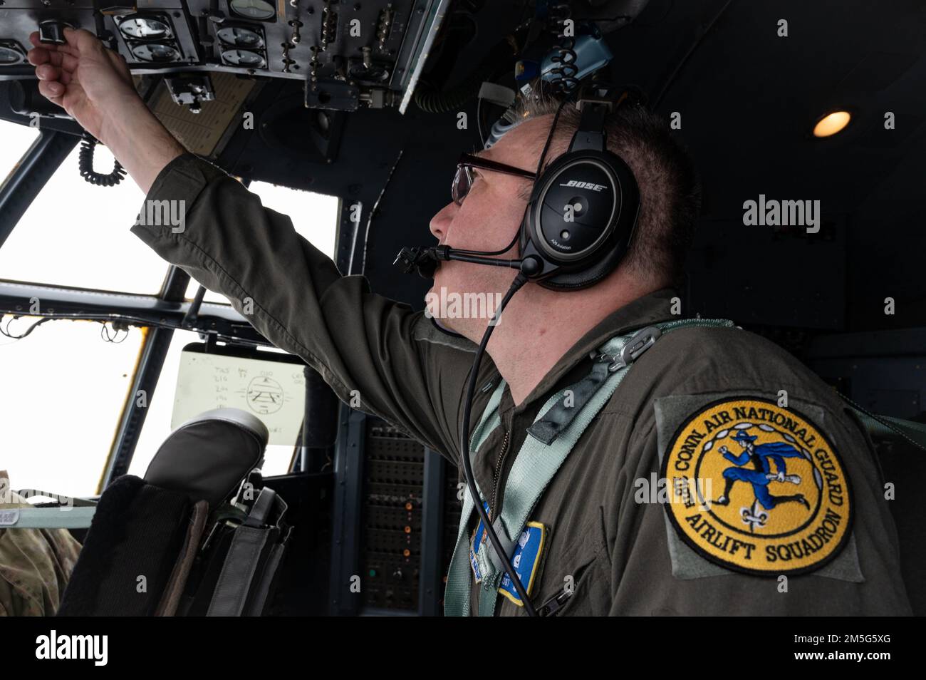 Air Force Master Sgt. Brian Sheldon, positions switches on a control ...