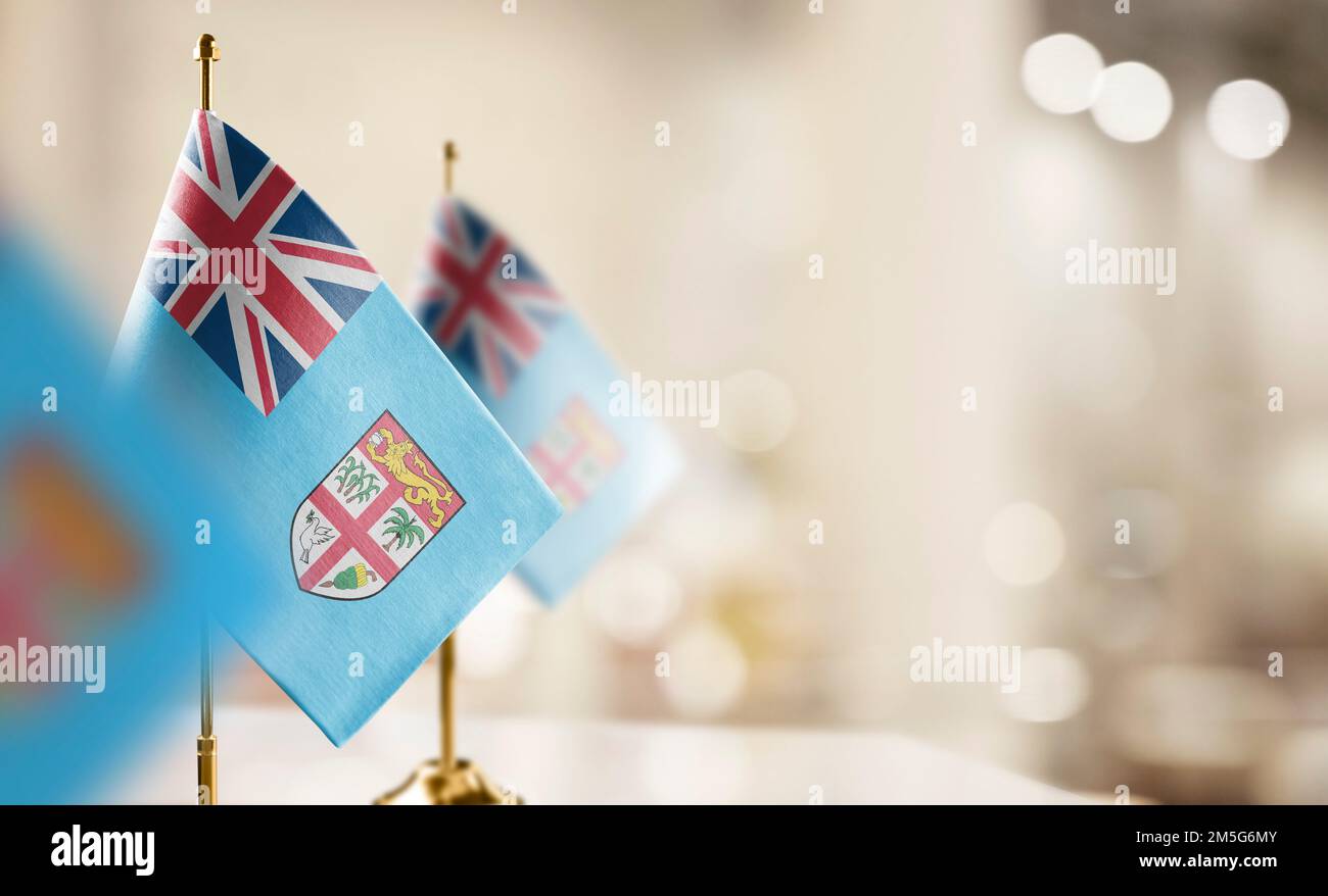 Small flags of the Fiji on an abstract blurry background Stock Photo ...