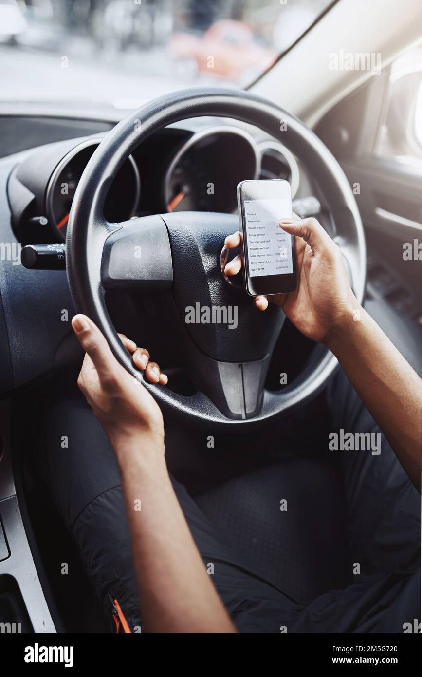 Dont be distracted on the road. an unrecognizable man using his phone ...