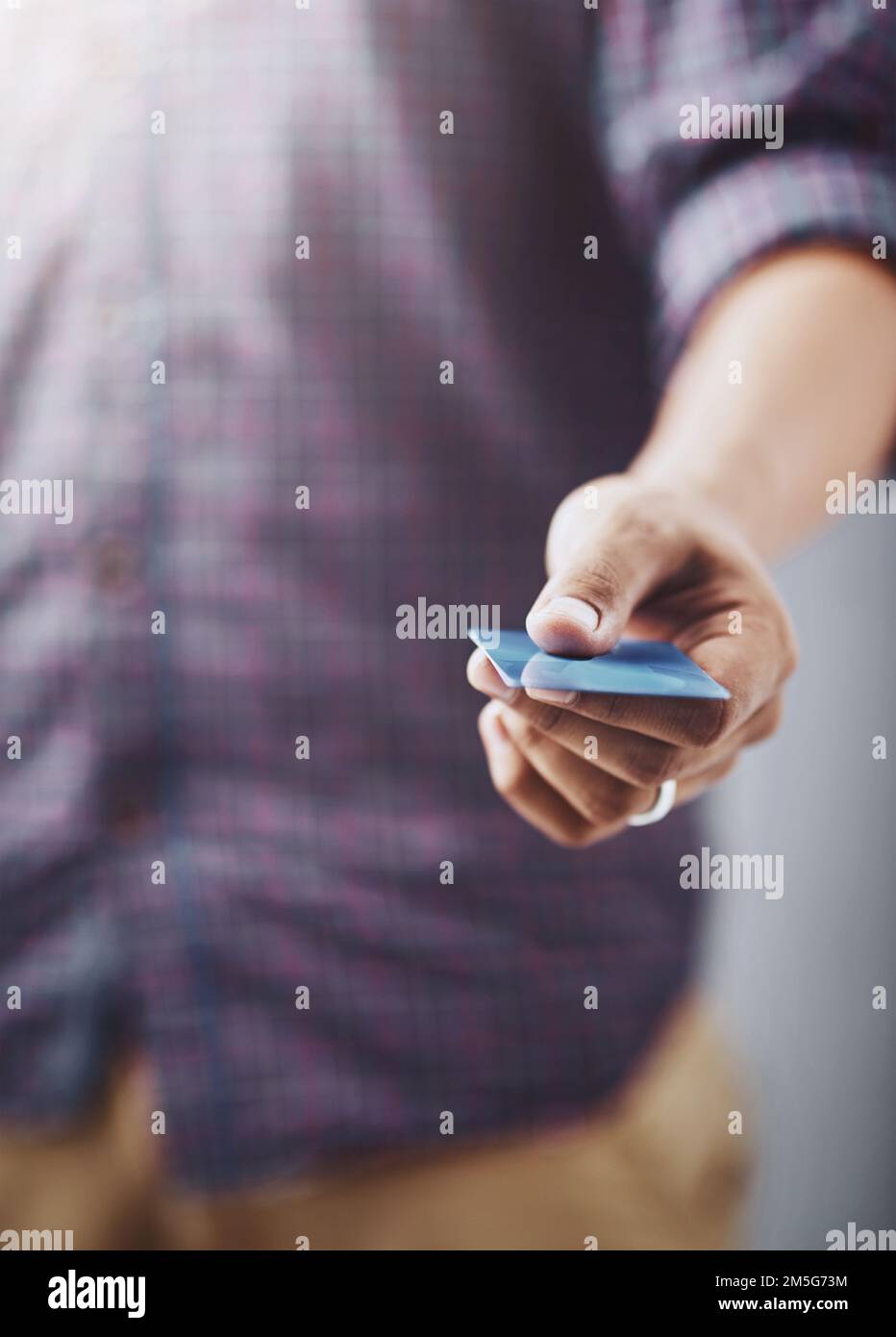 Put it on the credit card. an unrecognizable man holding his card out ... Put it on the credit card. an unrecognizable man holding his card out ...