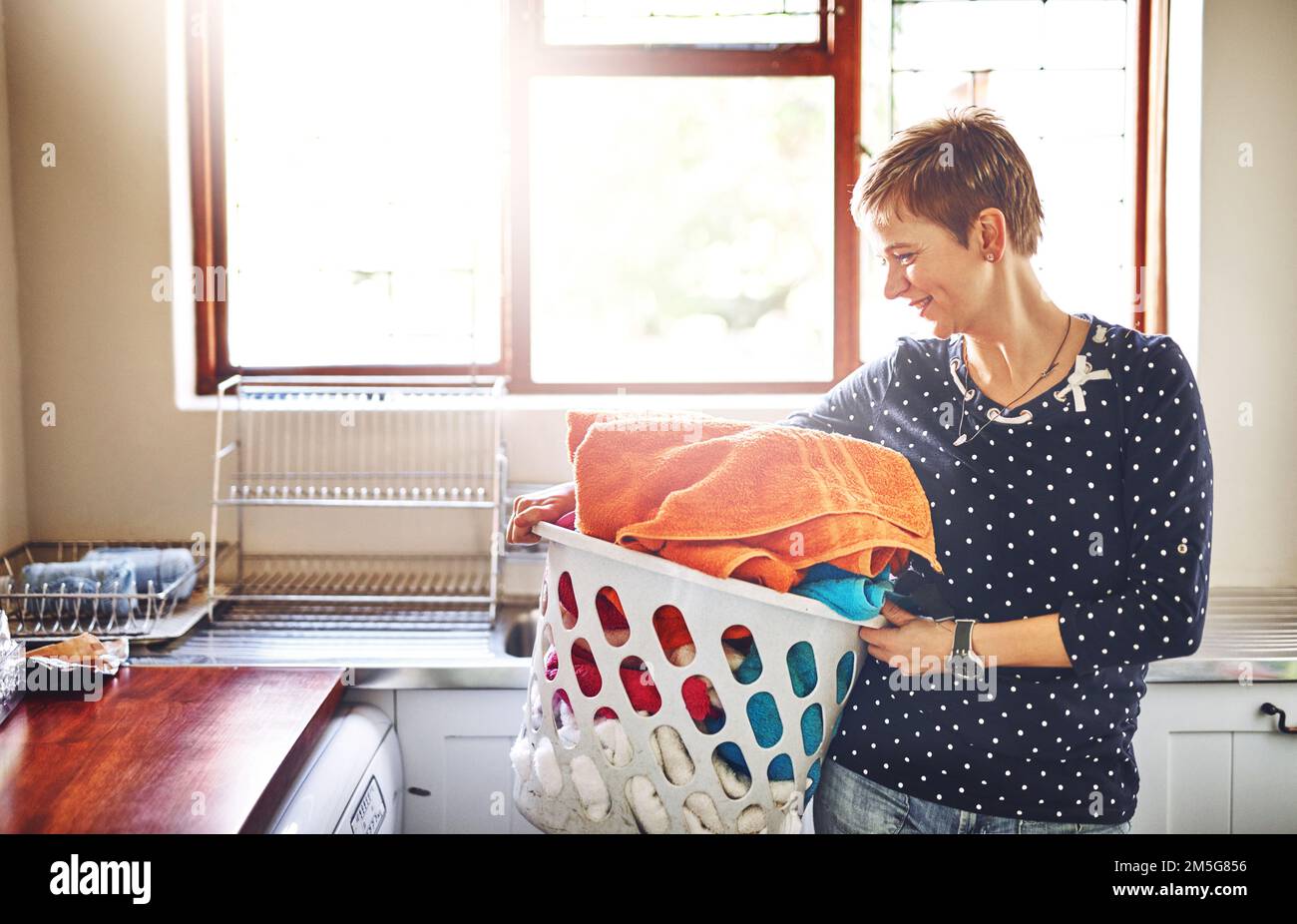 This is the last bunch of washing. a cheerful young woman sorting out a ...