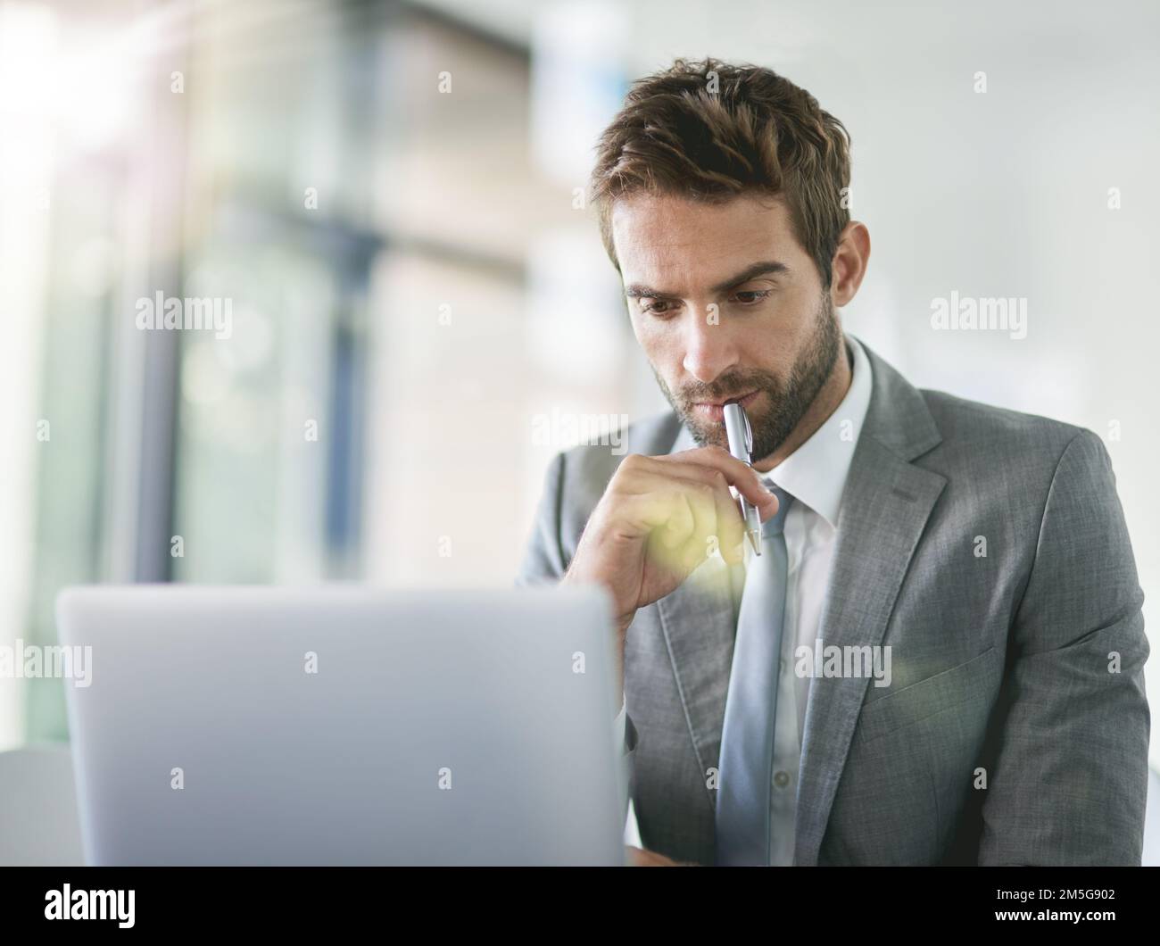 Hes a problem solver in business. a handsome young businessman working ...