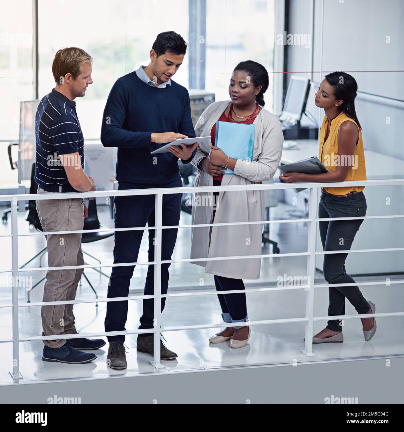 Running something by his colleagues. a group of colleagues working ...