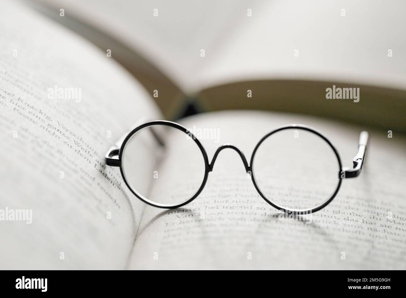 Reading concept.Education and schooling concept.Reading glasses on the ...