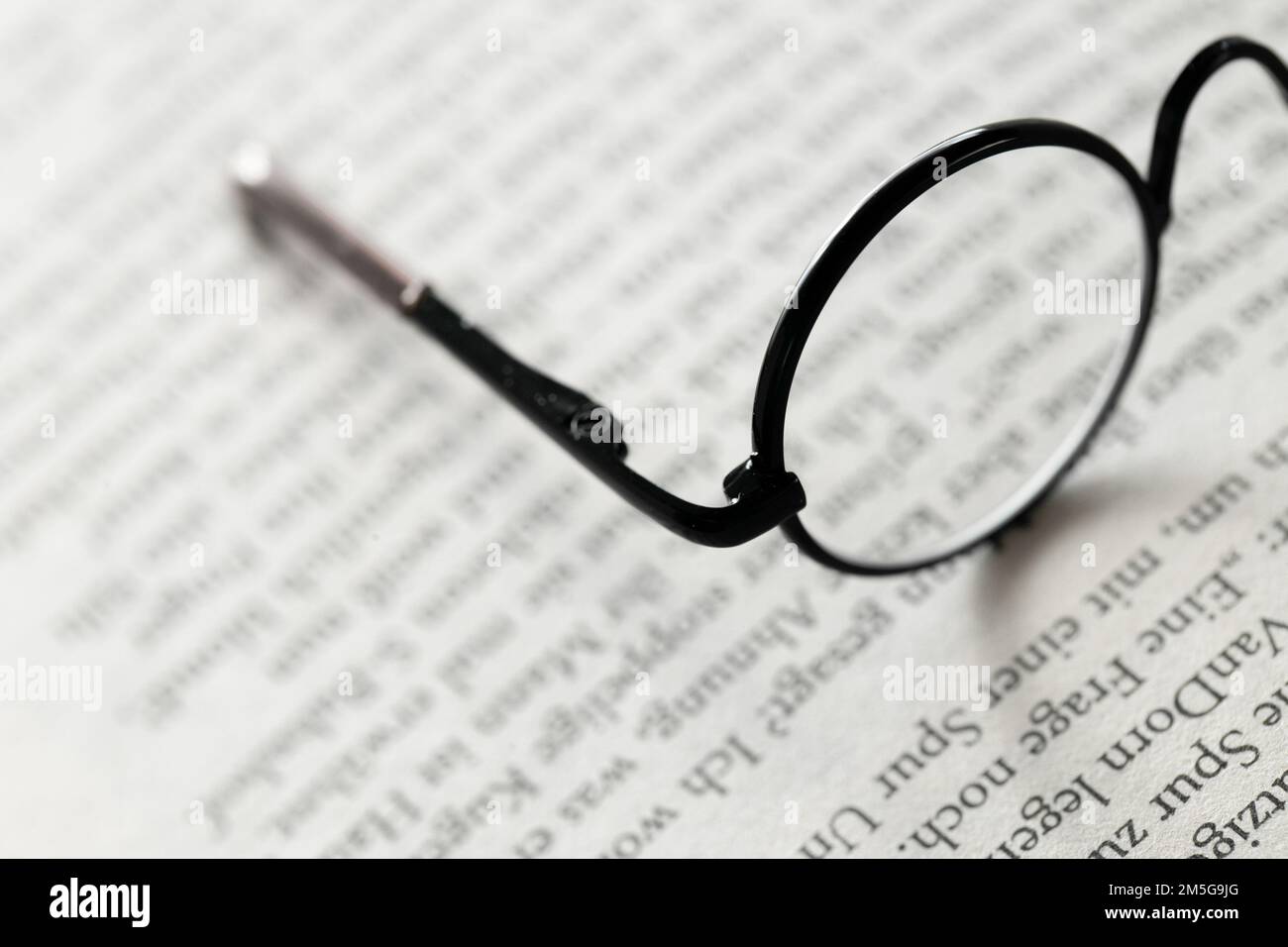 Reading glasses on the pages of a book .Symbol of study, knowledge and ...