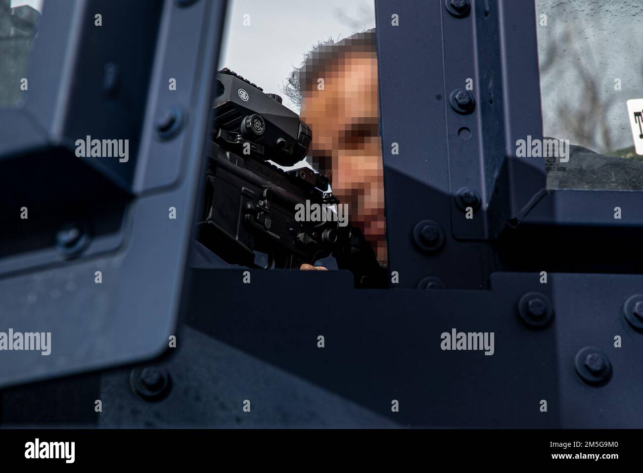 A member of Kosovo Special Intervention Unit aims his weapon at a ...