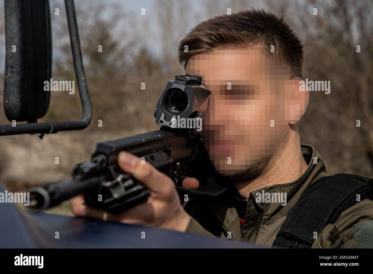 A member of Kosovo Special Intervention Unit aims his weapon at a ...