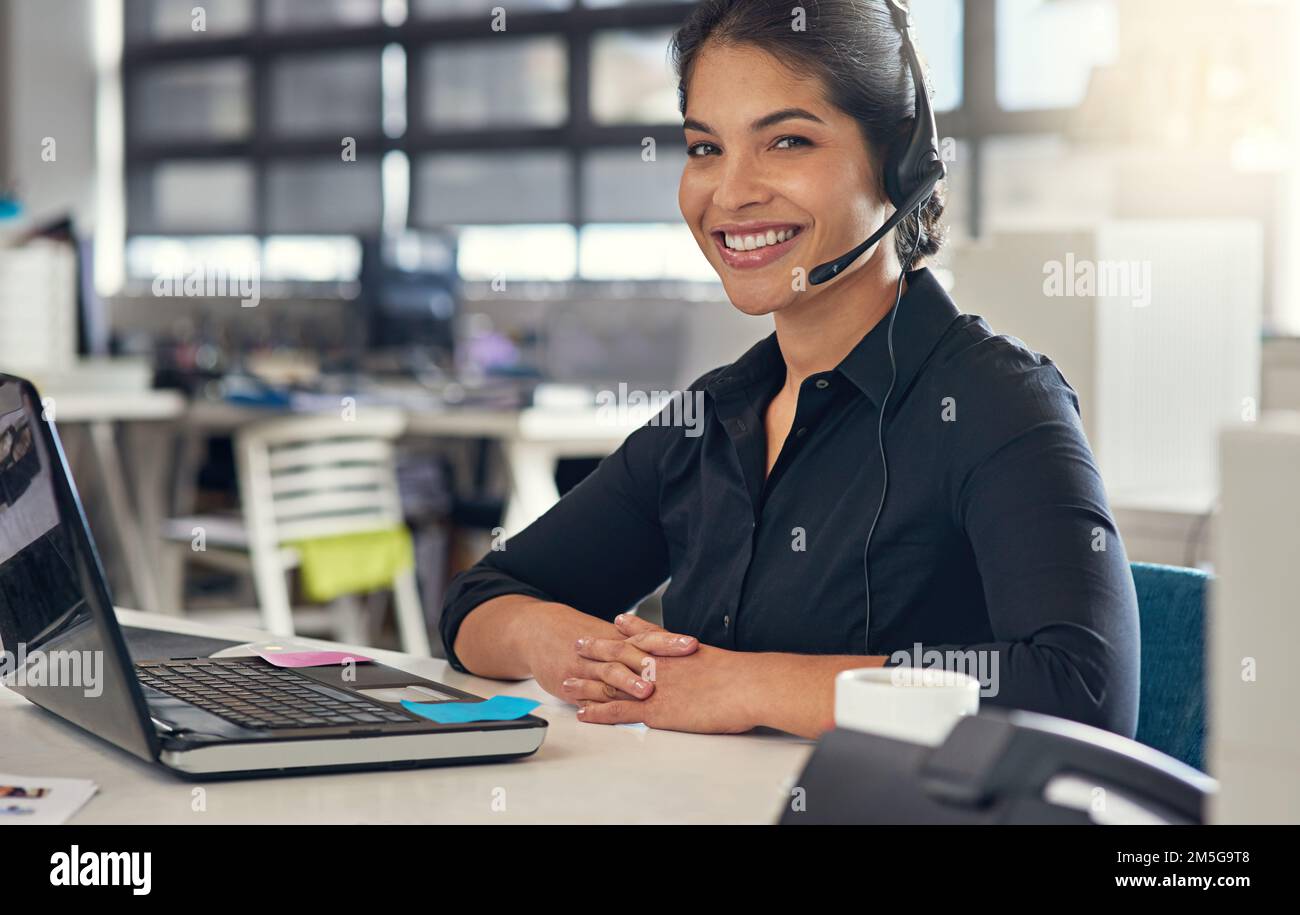 Im ready to take your call. a call centre agent sitting at her desk in ...
