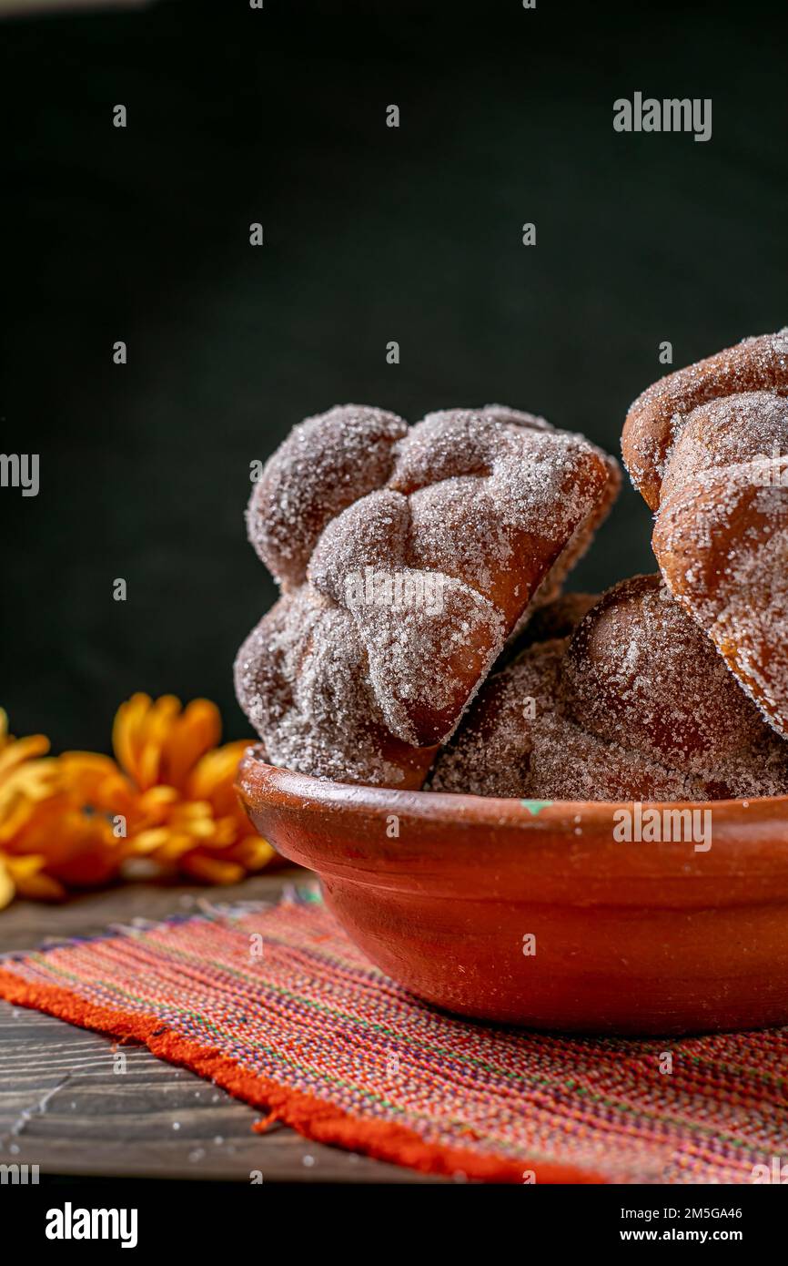 A vertical closeup shot of a traditional bread of the dead of mexico ...