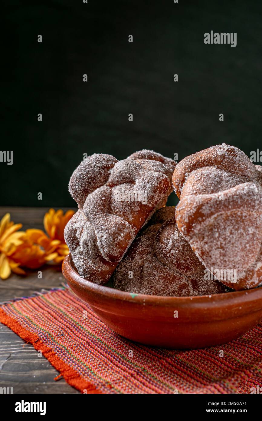 A vertical closeup shot of a traditional bread of the dead of mexico ...