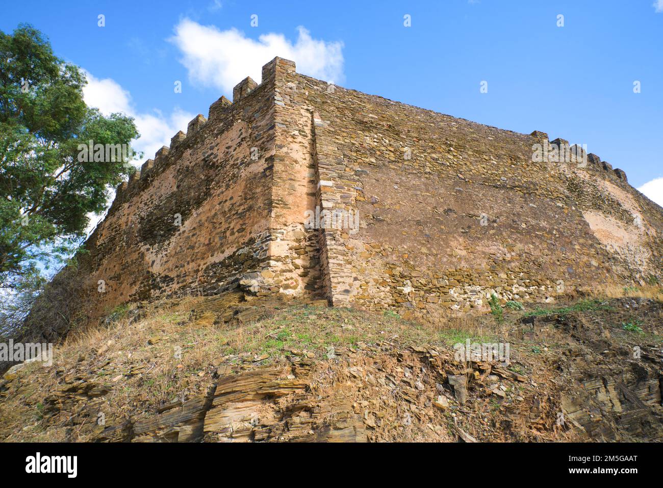 A detail view of the old, stone outer wall of the castle. At the ...