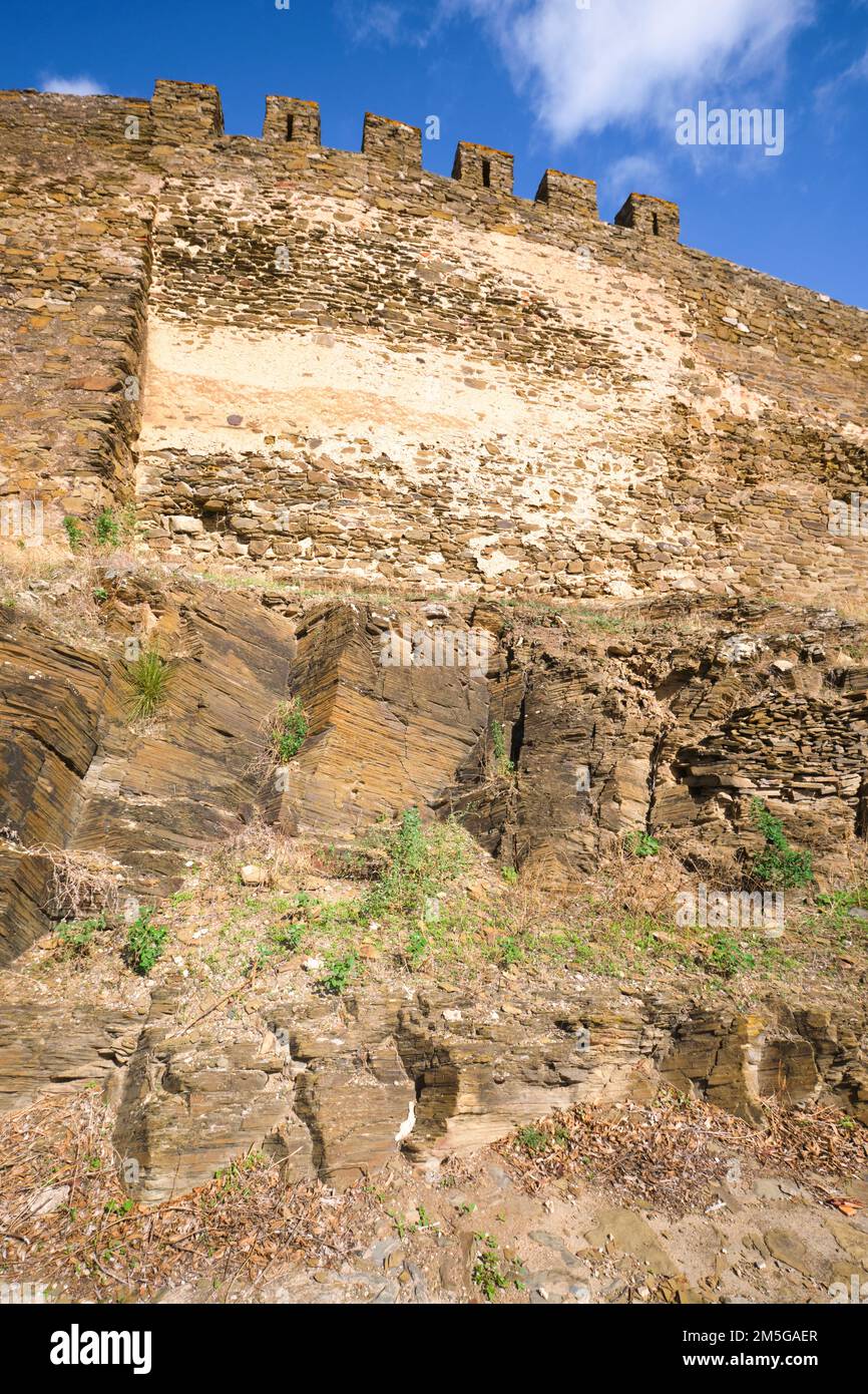 A detail view of the old, stone outer wall of the castle. At the ...