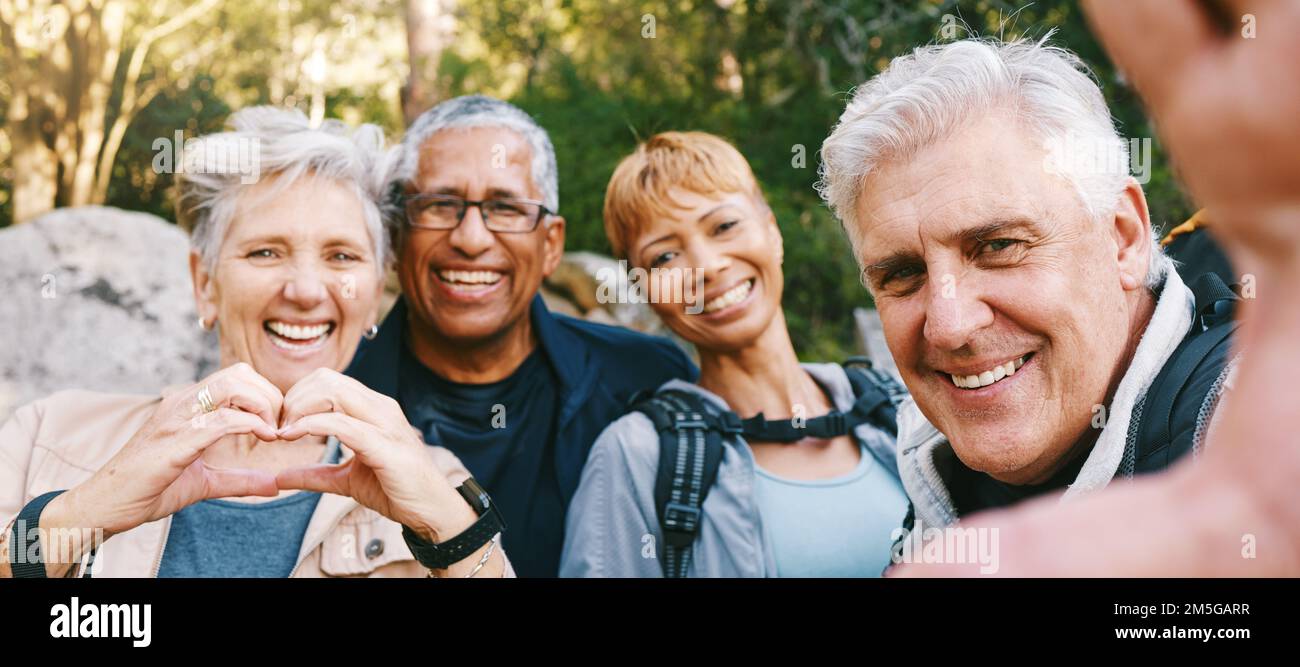Nature, selfie and senior friends hiking together in a forest while on ...