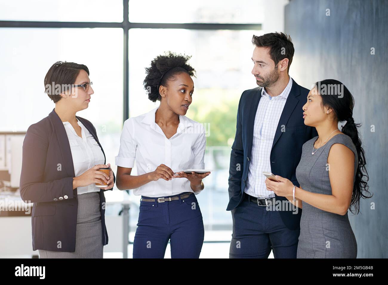 Communication is the key to success. a group of businesspeople talking ...