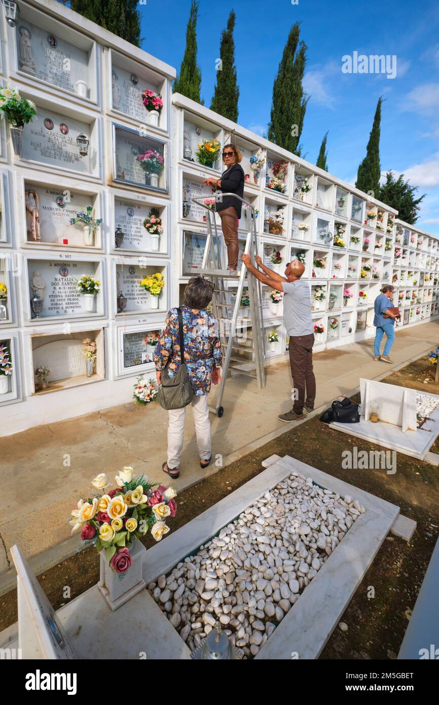 A family visiting relative tombs on the Day of the Dead, Novemver 1st ...