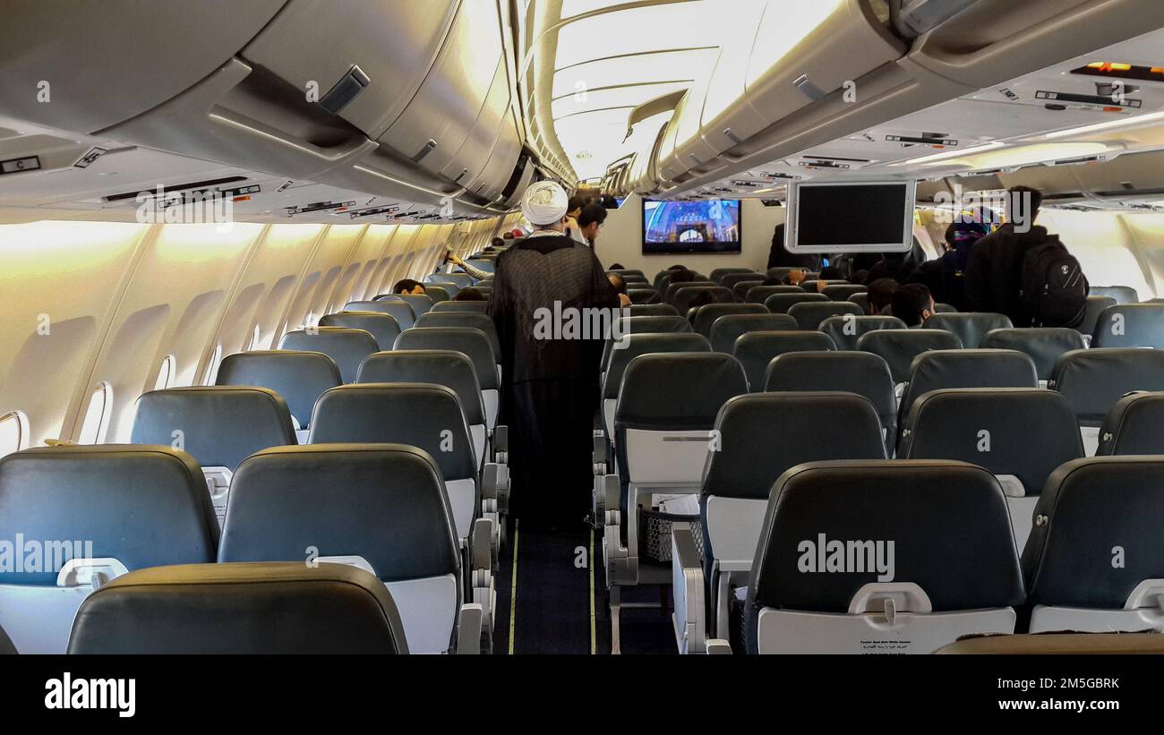 after landing passengers got ready for disembarkation from airplane ...