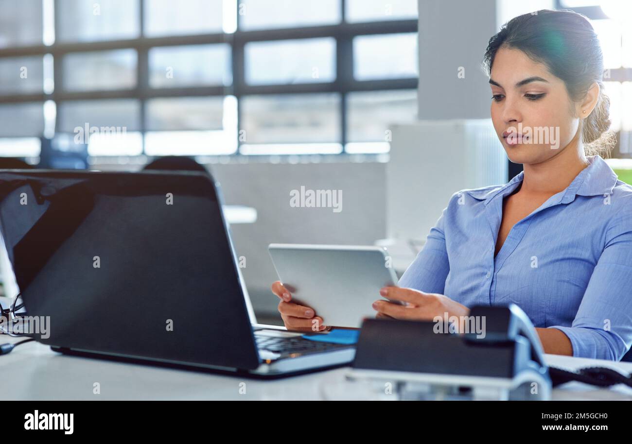 Wireless is the way forward. a focussed young businesswoman using her ...