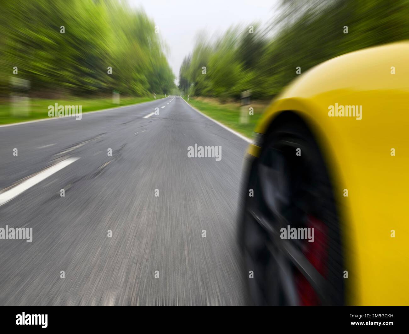 Photo with low camera perspective of car speeding at high speed without ...