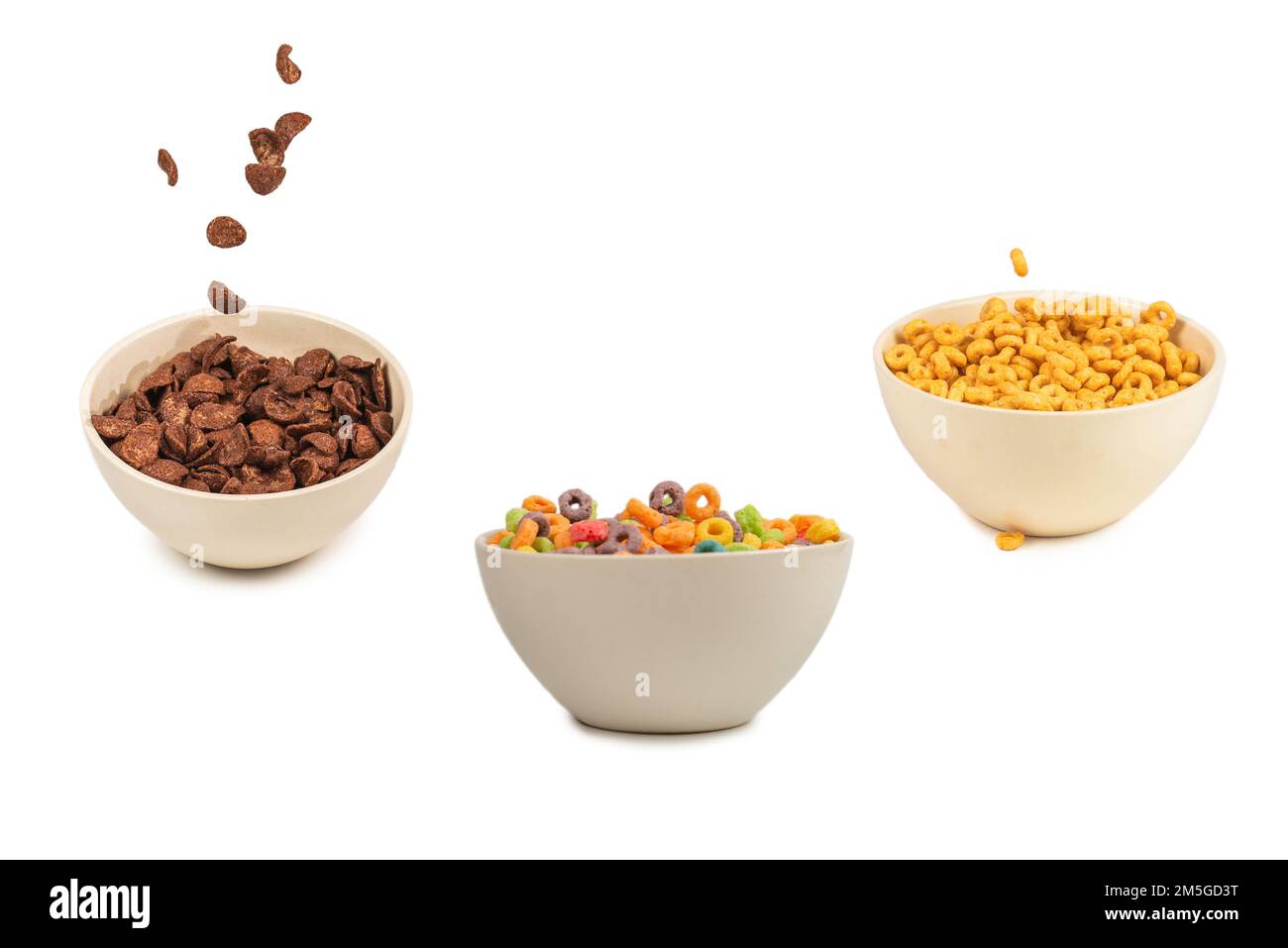 Chocolate corn flakes falling to the white bowl isolated on white ...