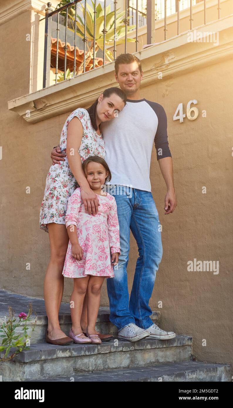 One happy family. Portrait of a happy family standing outside their ...