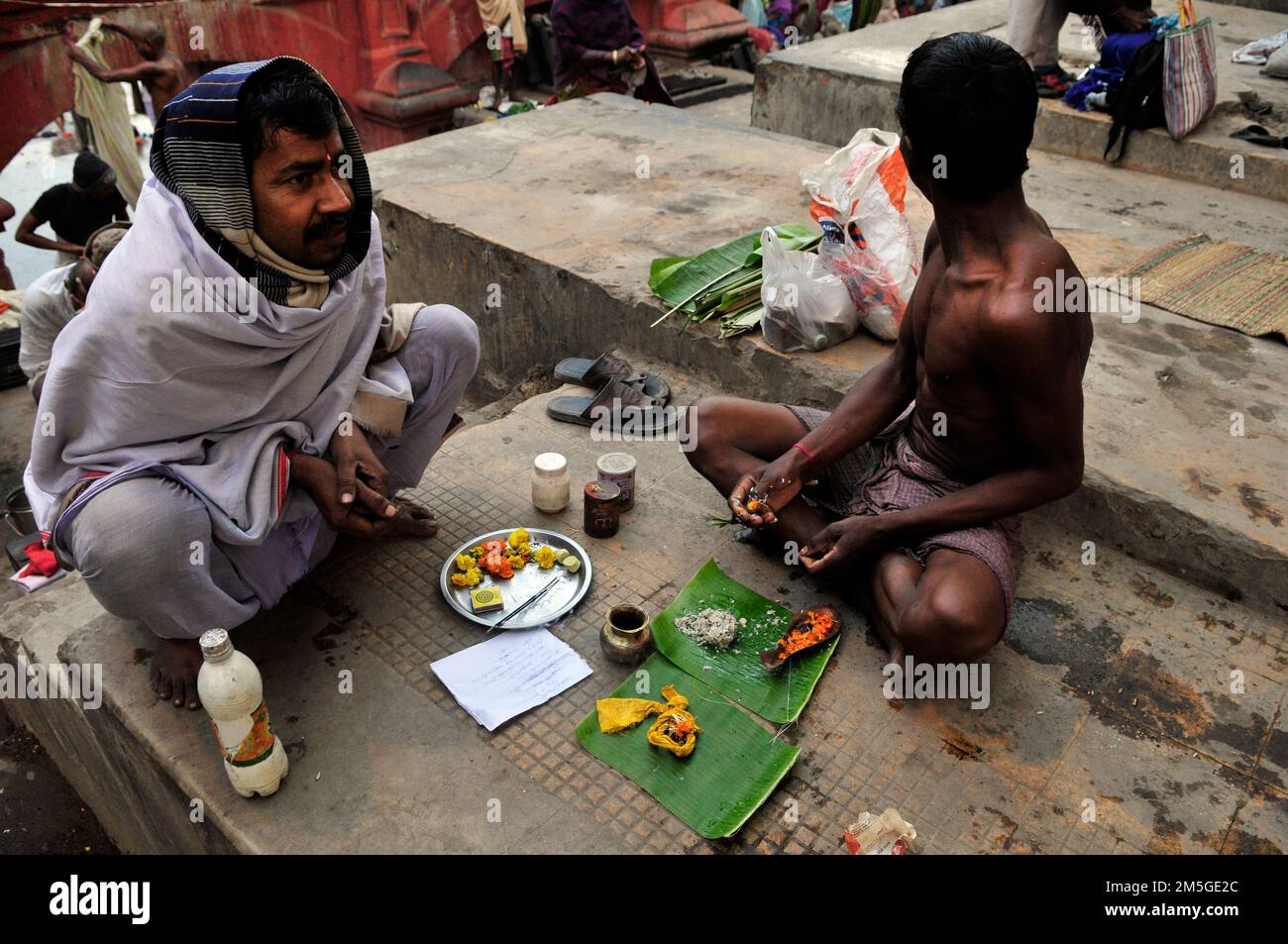 A Bengali man preparing items for a puja ceremony in Kolkata, India ...