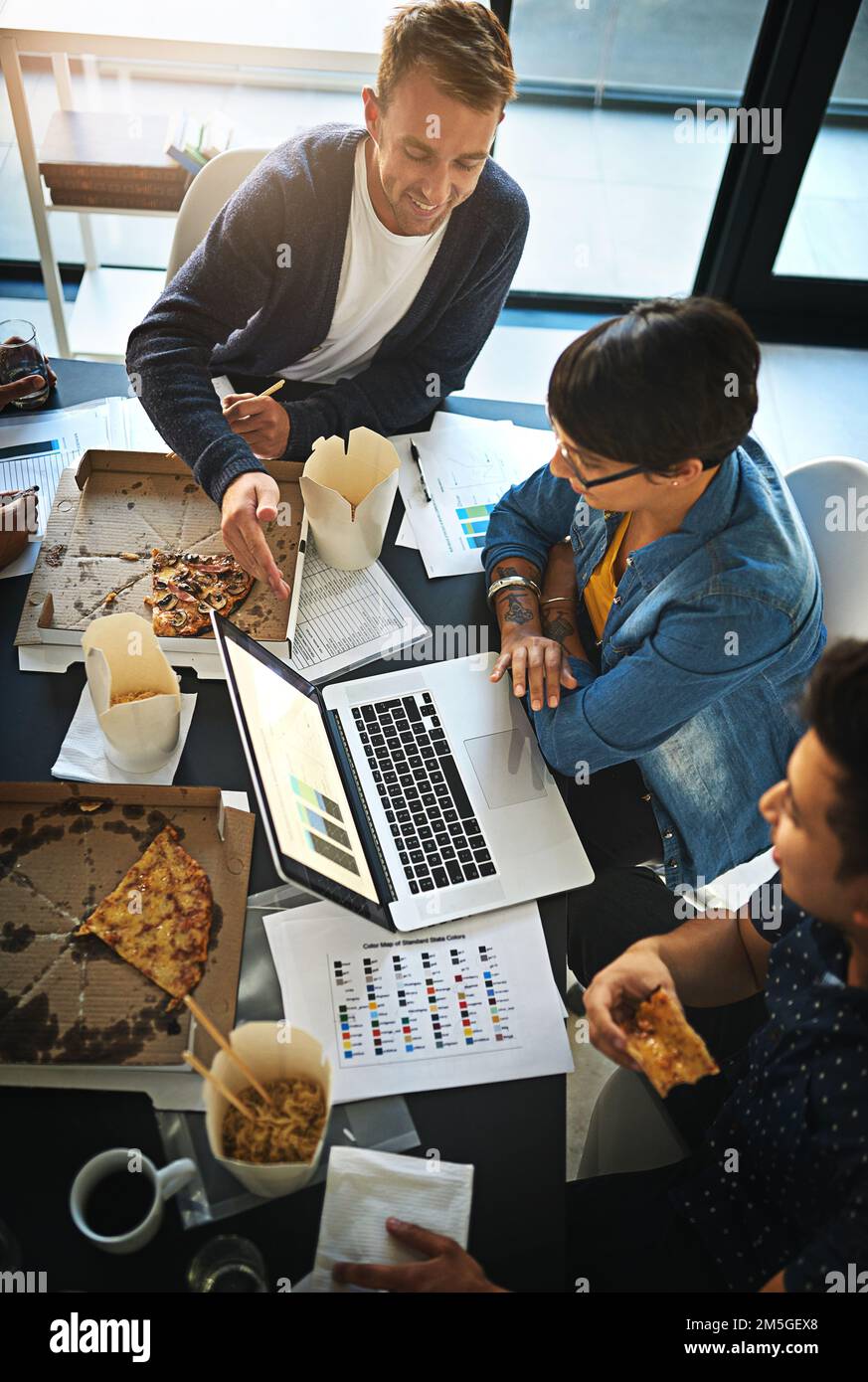 The numbers look good to me. a group of colleagues eating while having ...