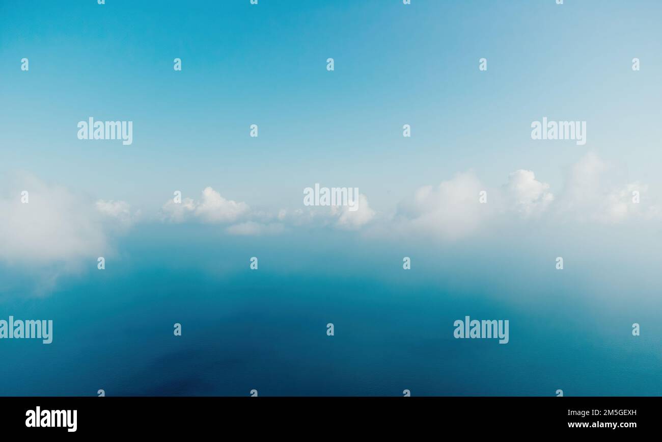 Blue sky with white clouds over calm summer panorama of the sea. Drone ...