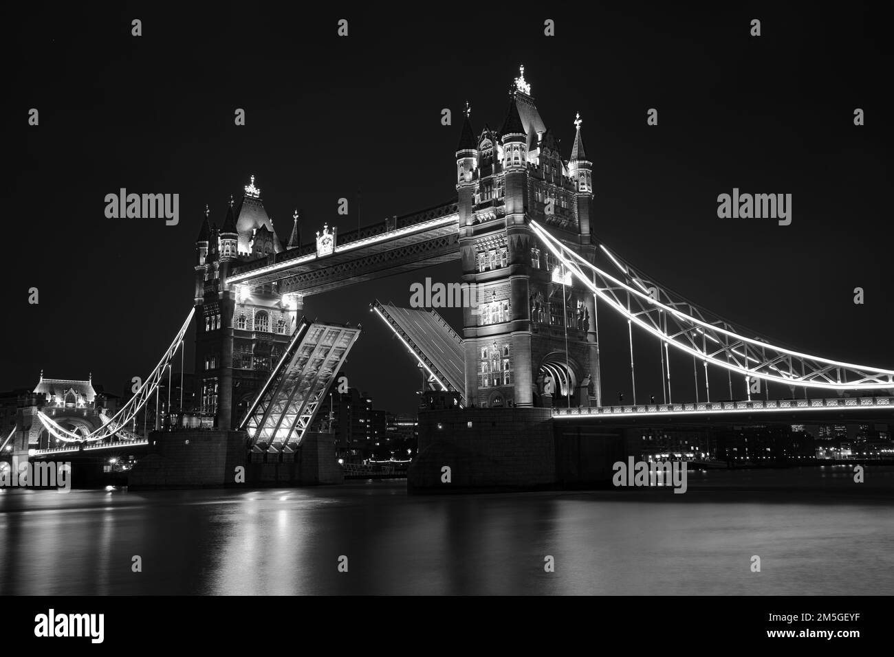 Illuminated Tower Bridge in London at night, black and white, London ...
