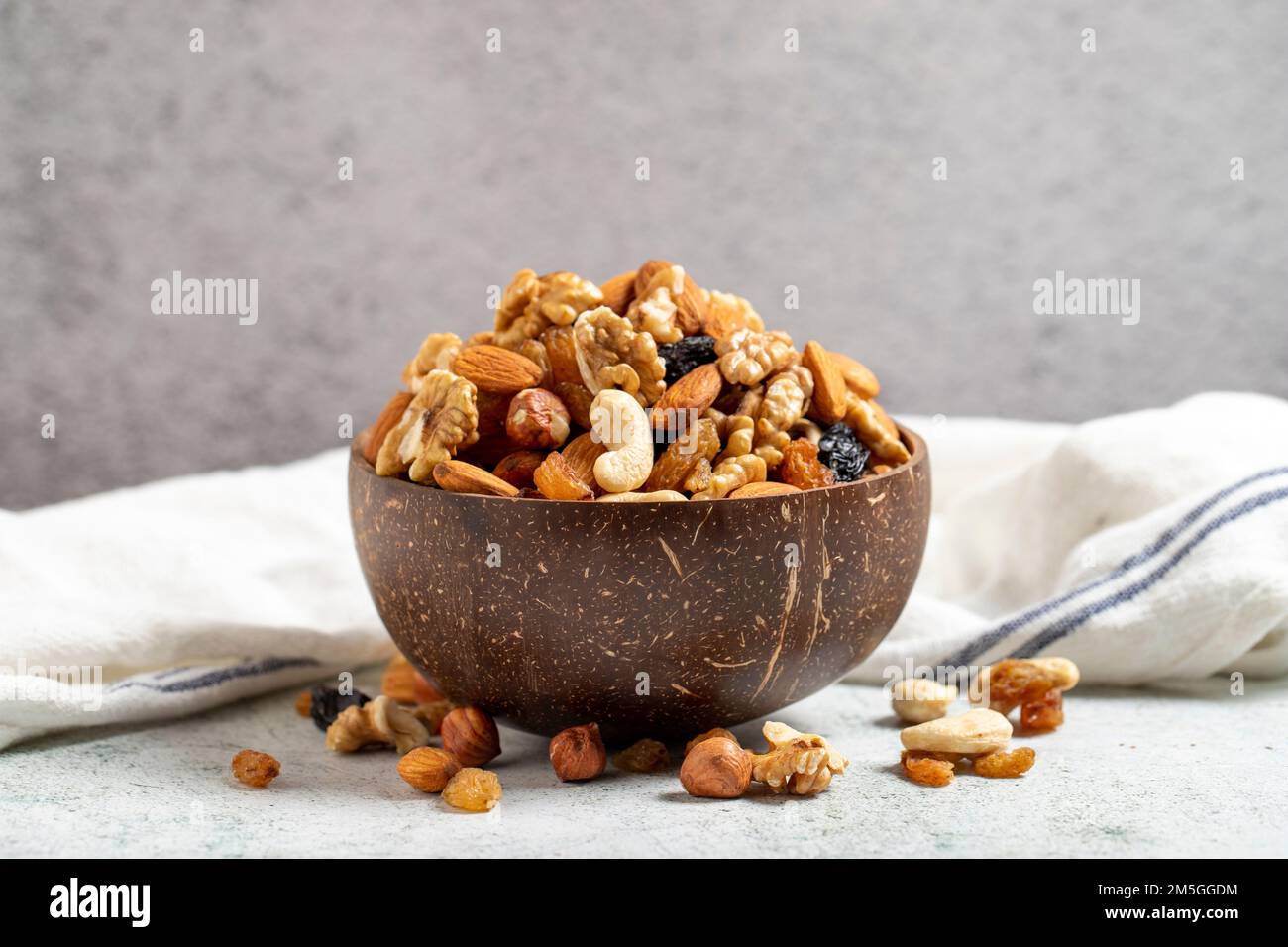 Raw mixed nuts on gray background. Walnuts, almonds, hazelnuts and ...
