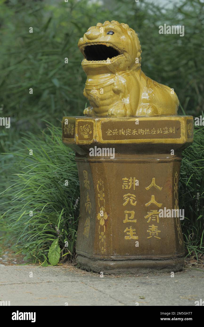 Mythical creature on pedestal with inscription in the Chinese Garden ...