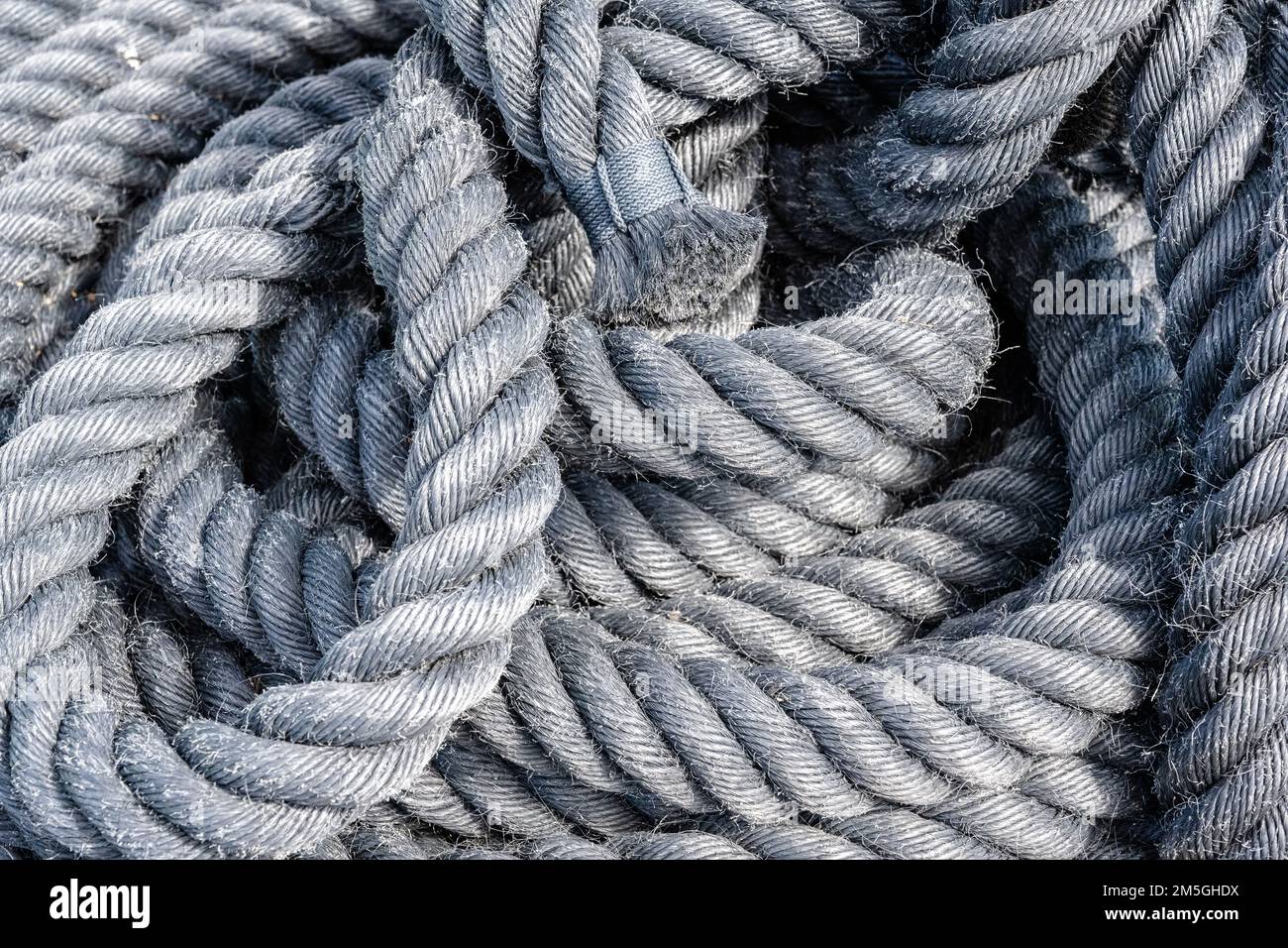 Coil of weathered grey ships rope Stock Photo - Alamy