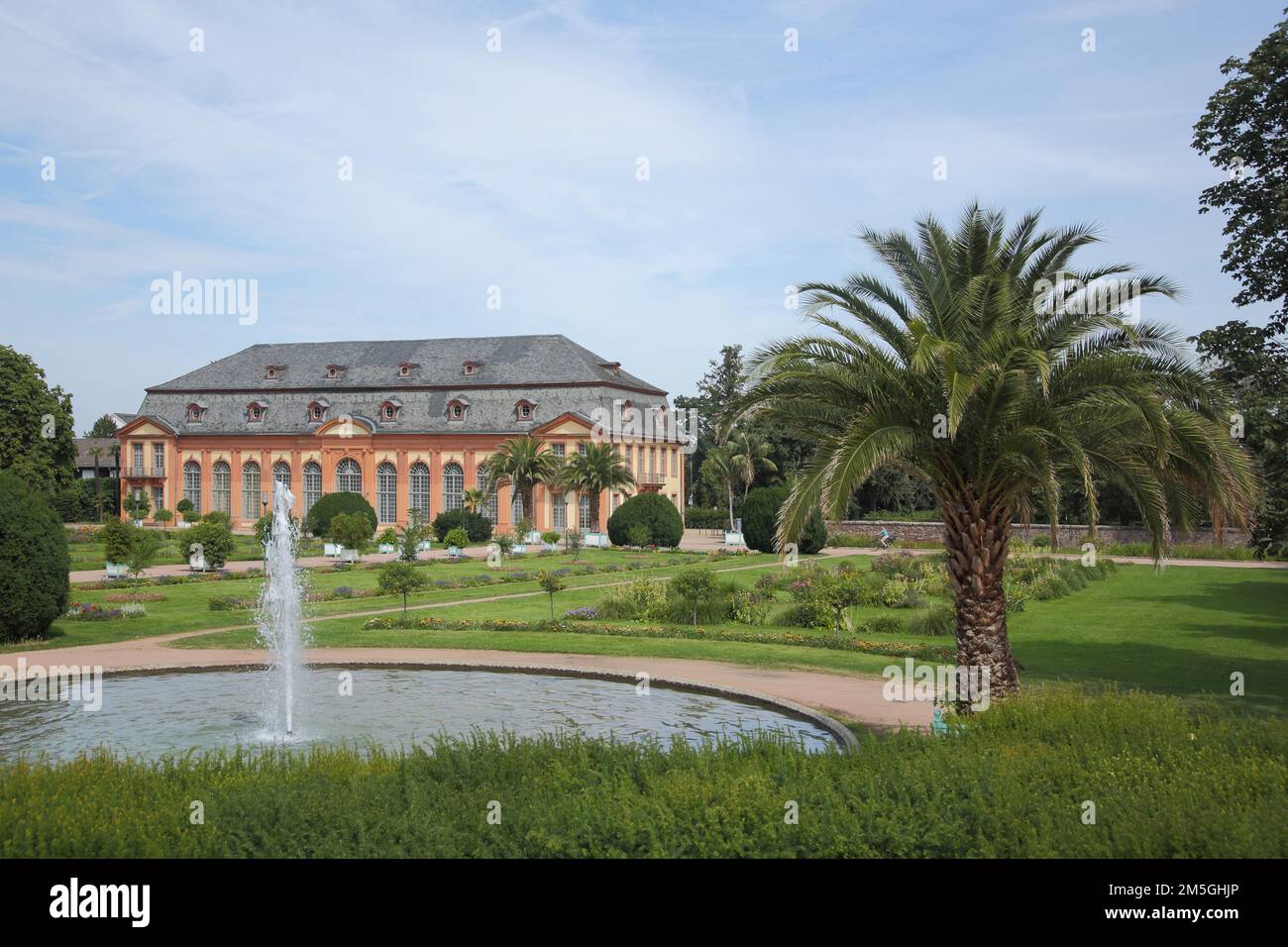 Orangery with ornamental garden, palm tree and fountain with fountain ...