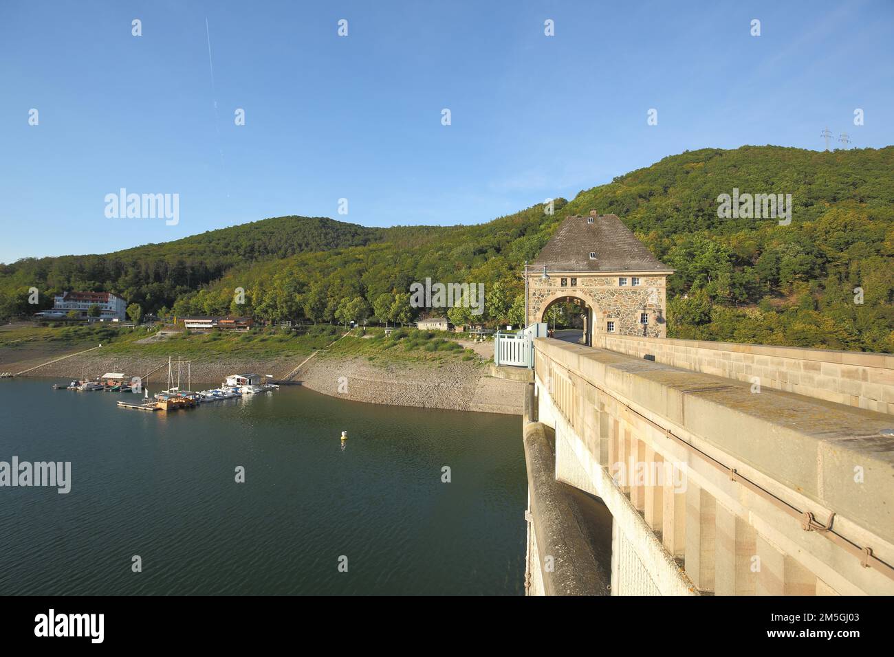 Landscape and dam wall with gatehouse and landing stage at the Eder dam ...