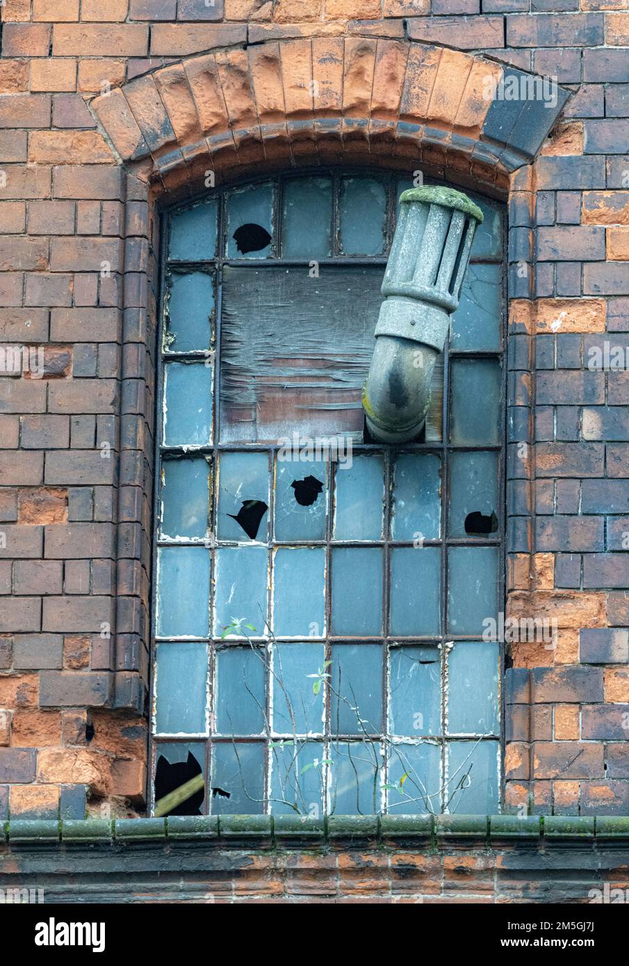 Dilapidated window in an abandoned city centre industrial building ...