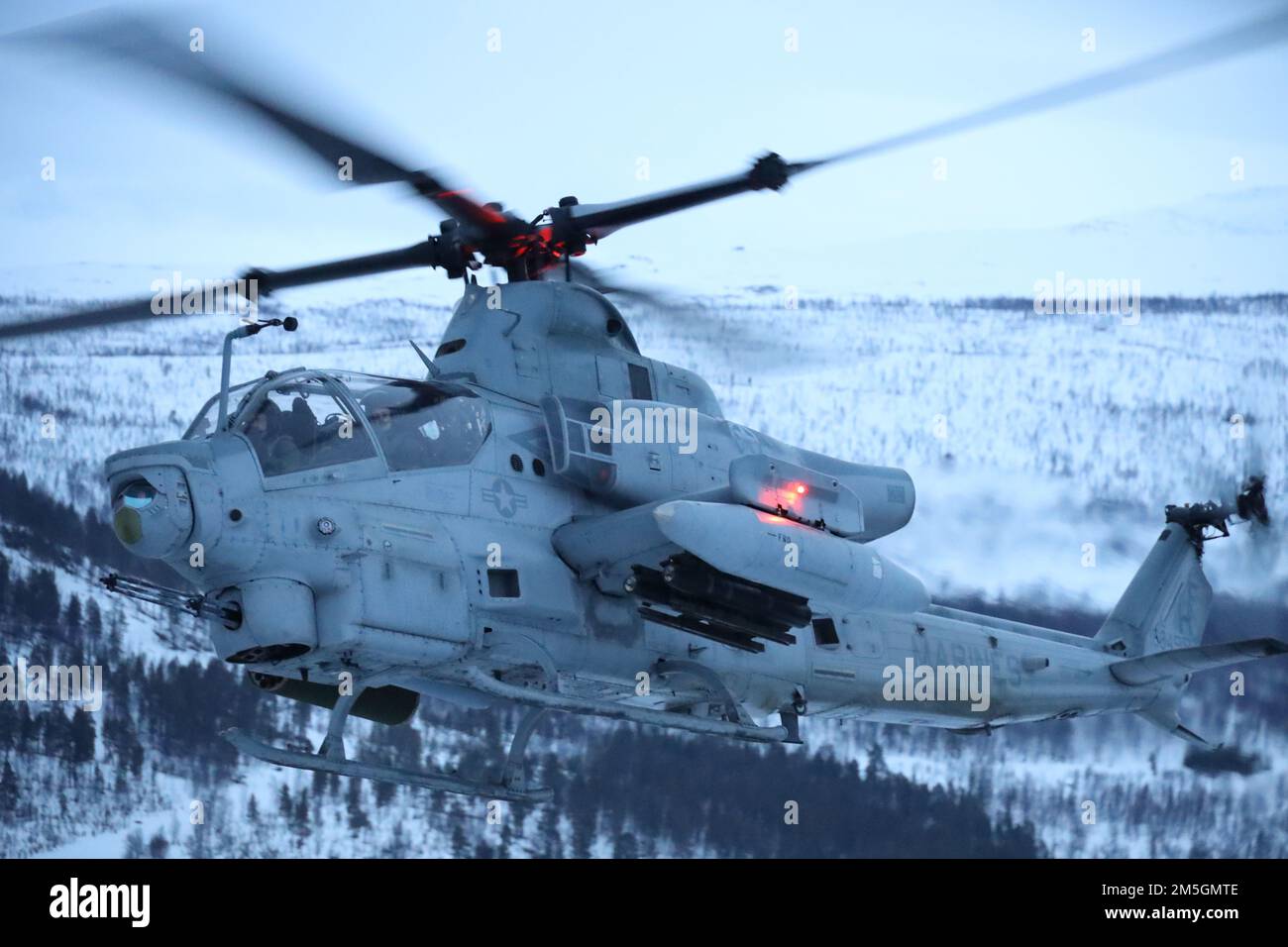 U.S. Marine Corps Capt. Joseph Rule and Maj. Brain Blanco maneuver a AH ...