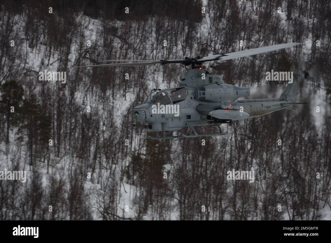 U.S. Marine Corps Capt. Joseph Rule and Maj. Brain Blanco maneuver a AH ...