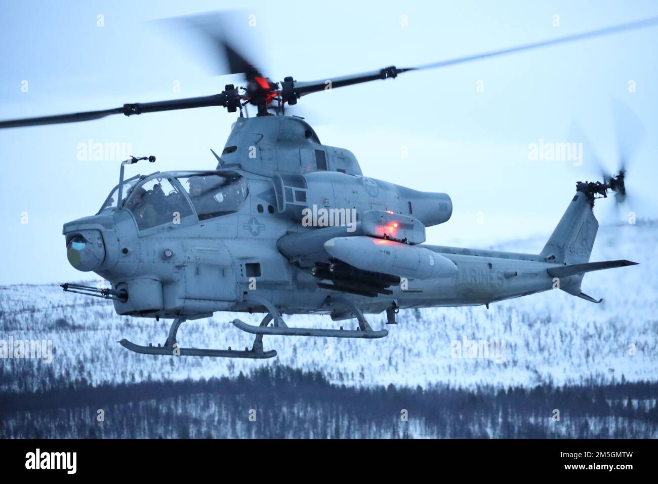 U.S. Marine Corps Capt. Joseph Rule and Maj. Brain Blanco maneuver a AH ...