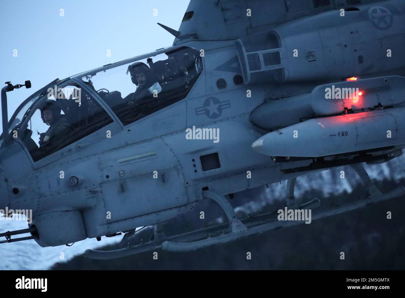 U.S. Marine Corps Capt. Joseph Rule and Maj. Brain Blanco maneuver a AH ...