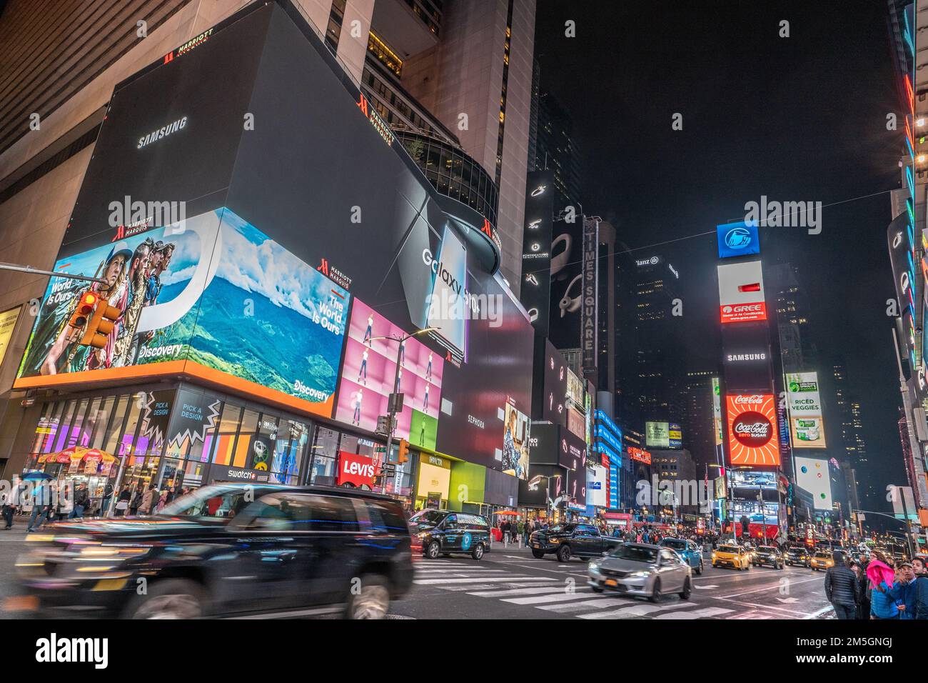 A beautiful shot of crowds of people and cars in Times Square at night ...