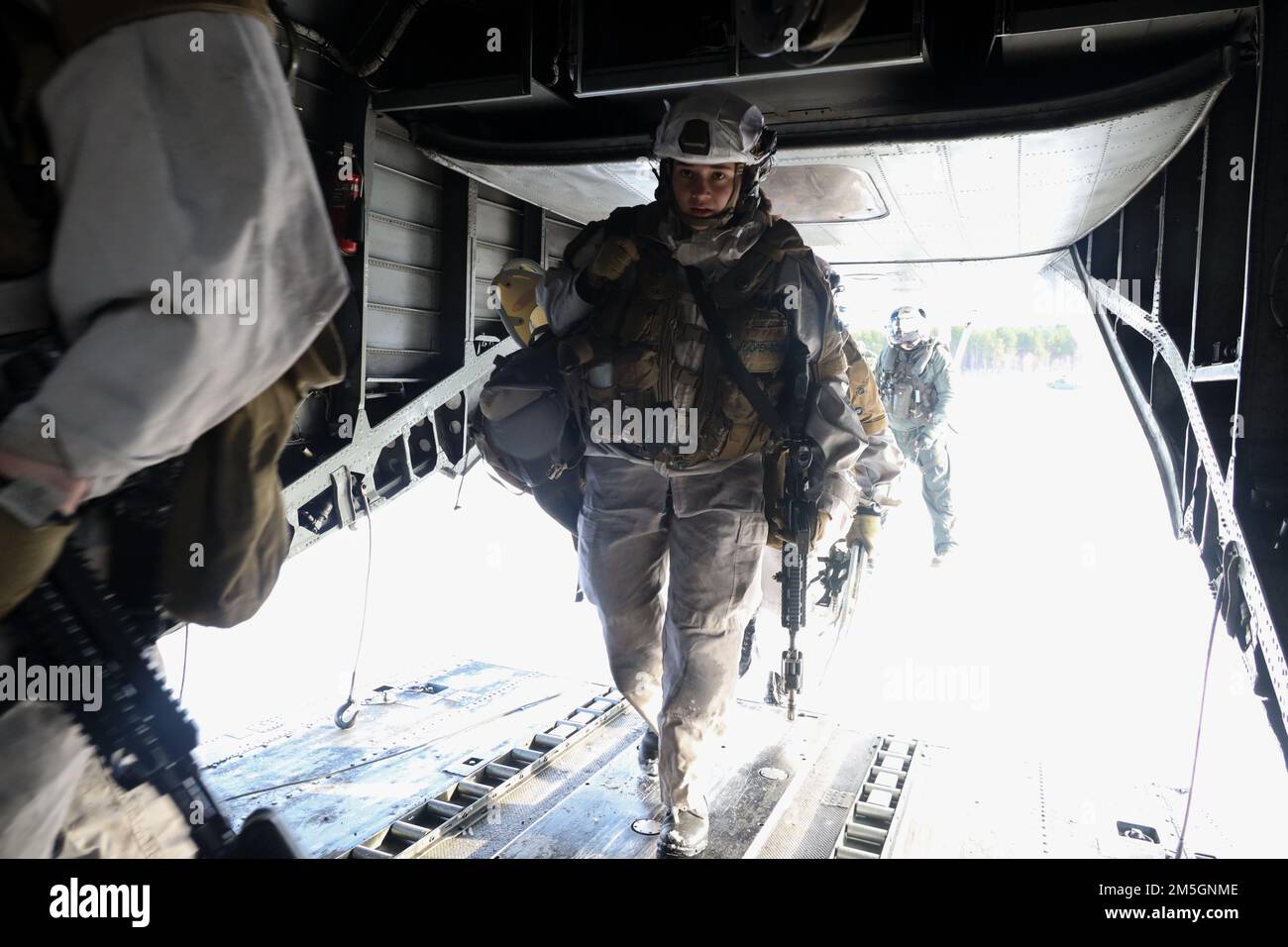 U.S. Marine Corps Staff Sgt. Matthew Jensen assists a Norwegian soldier ...