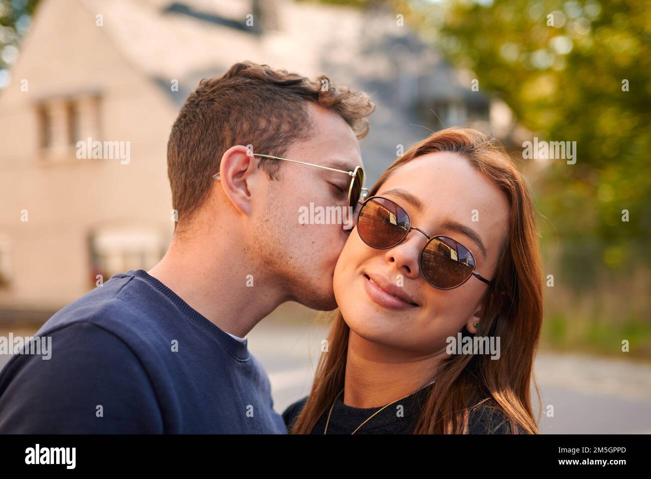 Male kissing female on cheek hi-res stock photography and images - Alamy
