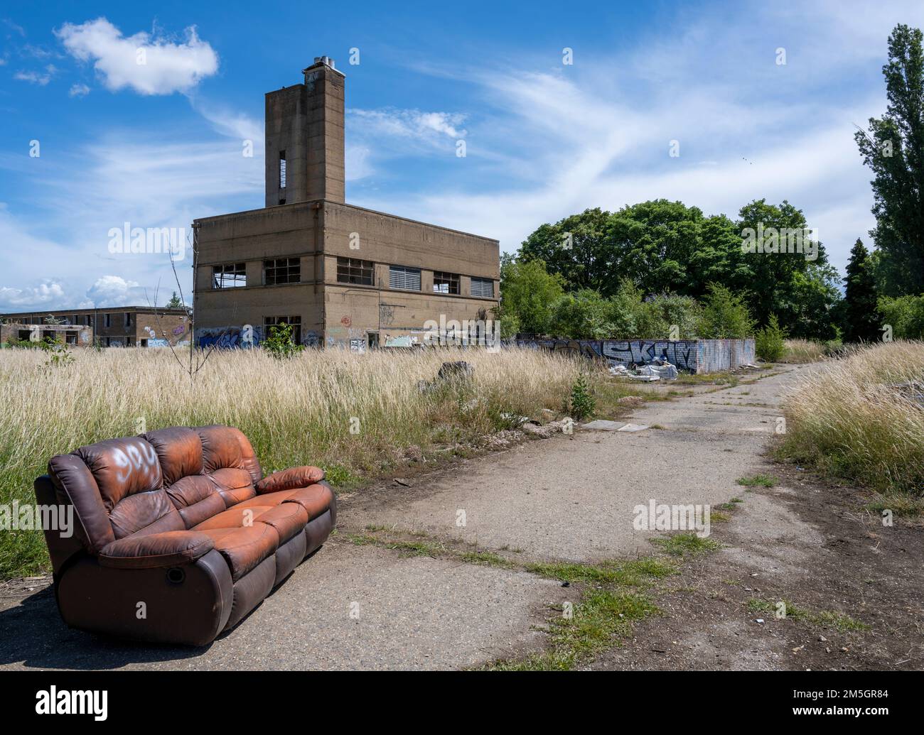 Sofa fly tipped on an abandoned airfield Stock Photo - Alamy