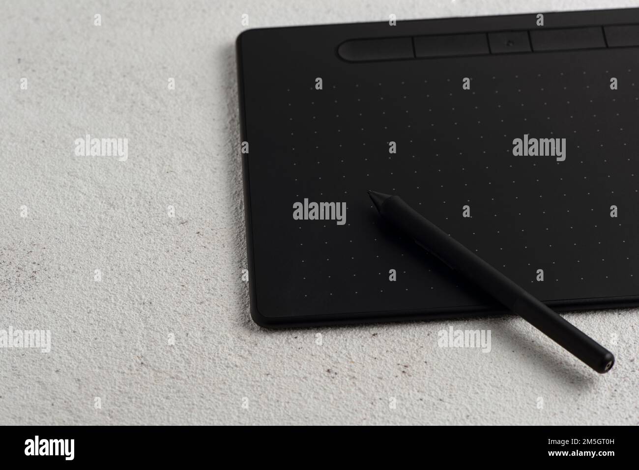 The graphic tablet with a stylus on a white background Stock Photo - Alamy
