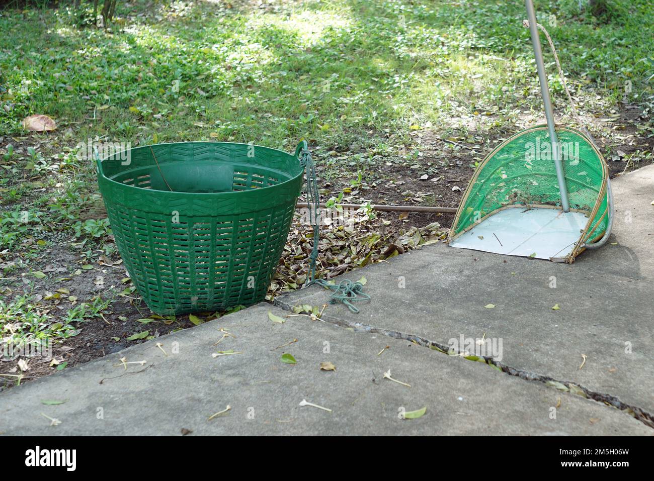 A green basket for sweeping, placed on the aisle Stock Photo - Alamy
