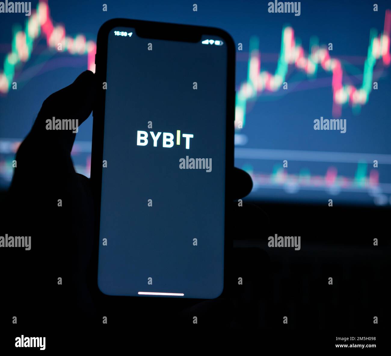 Bybit mobile app crypto exchange on mobile phone screen against blurred ...