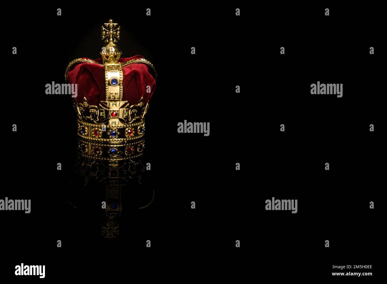 Golden crown on a black background with reflection and with copy space ...