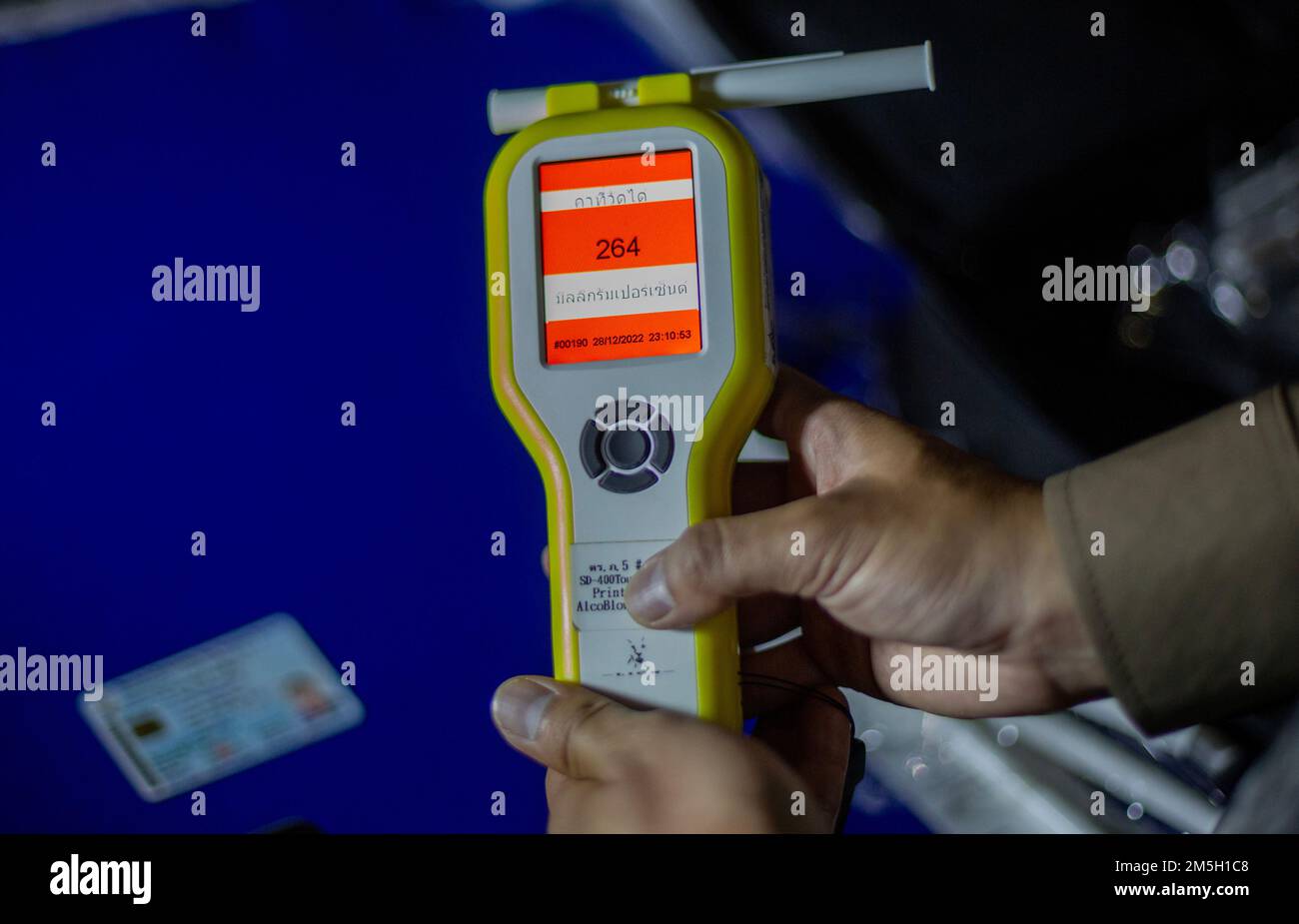 A Thai police officer shows the breathalyzer with a higher than normal ...