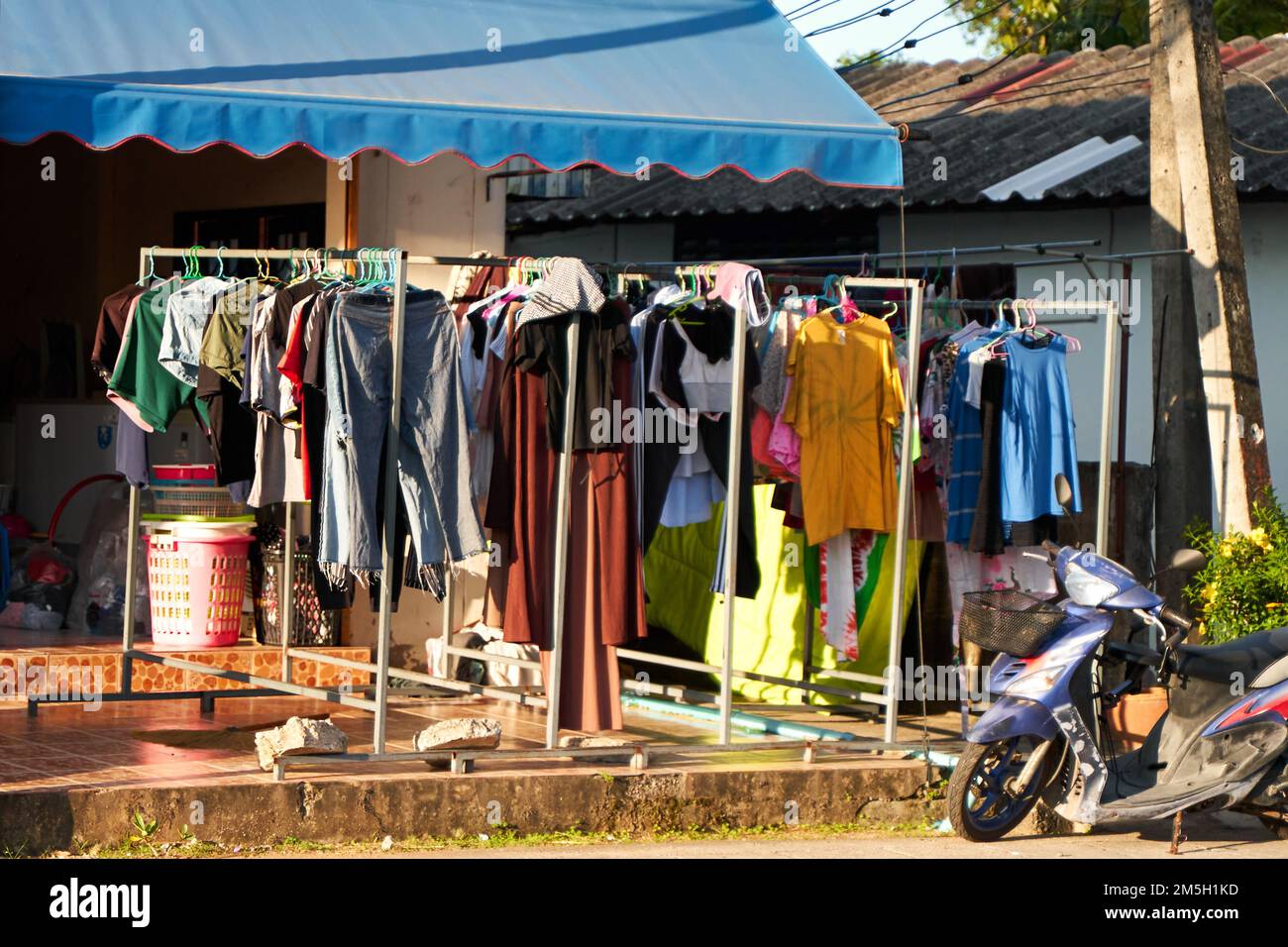 Clothes hangers second hand on the street in front of the house. Sale ...