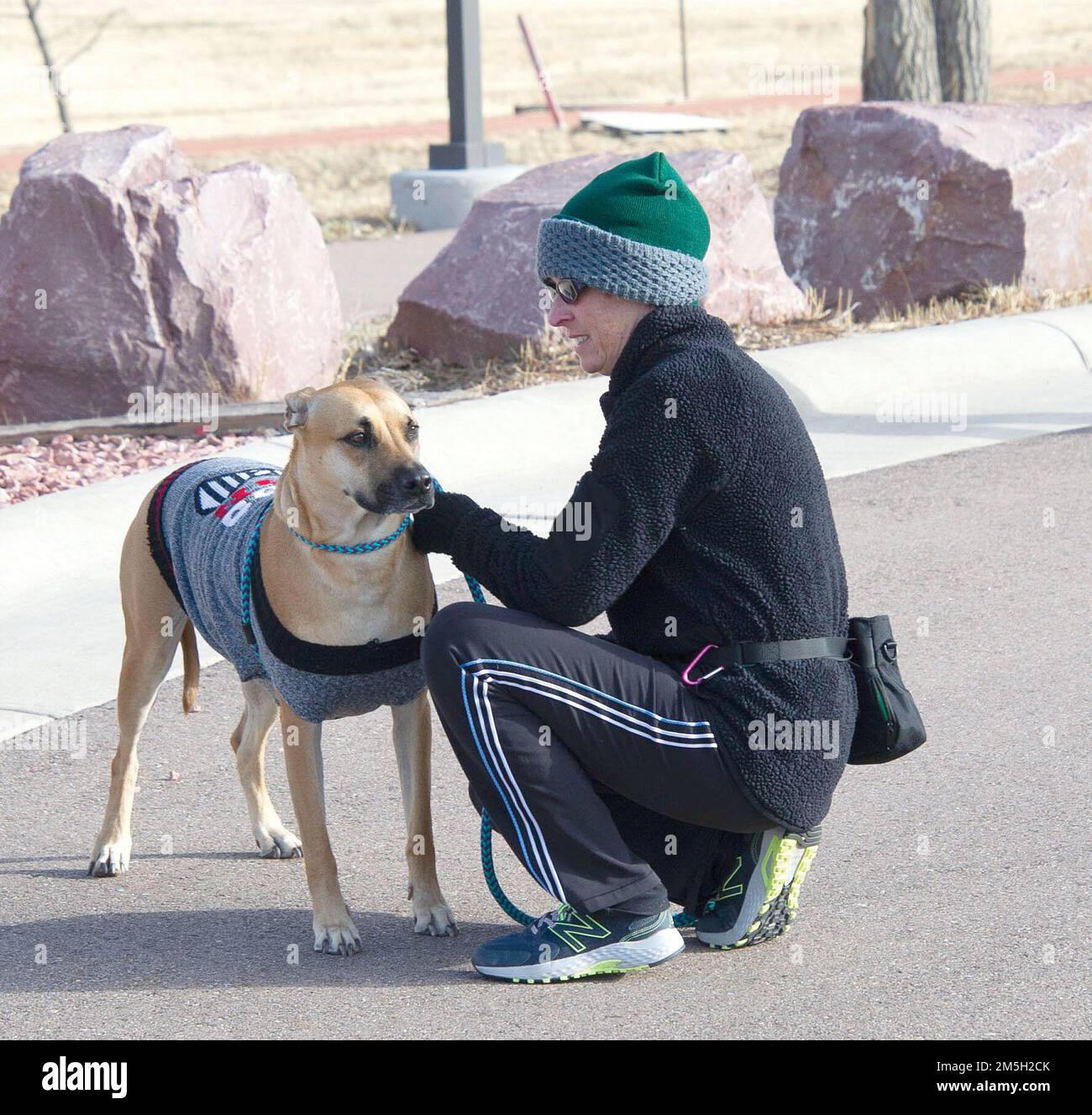 FORT CARSON, Colo. — A runner prepares her dog to take part in the St ...