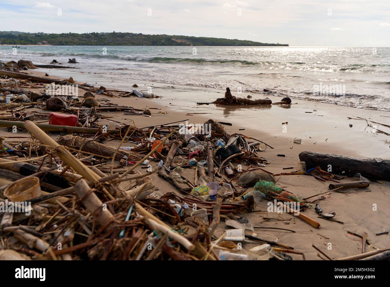 Mountains of waste and garbage on the sandy beach after the tide ...